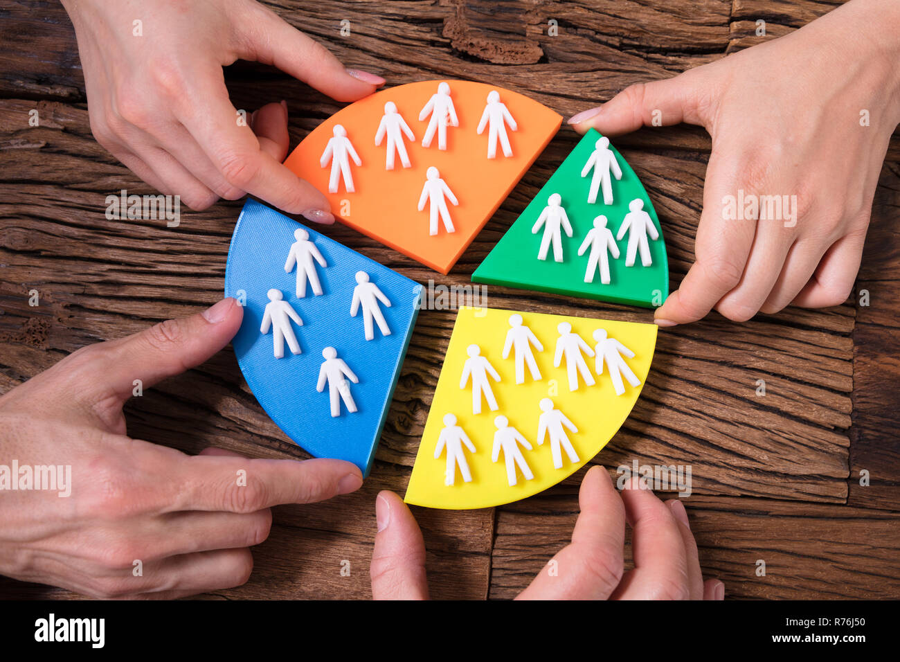Businesspeople Connecting Pie Chart With Human Figures Stock Photo - Alamy