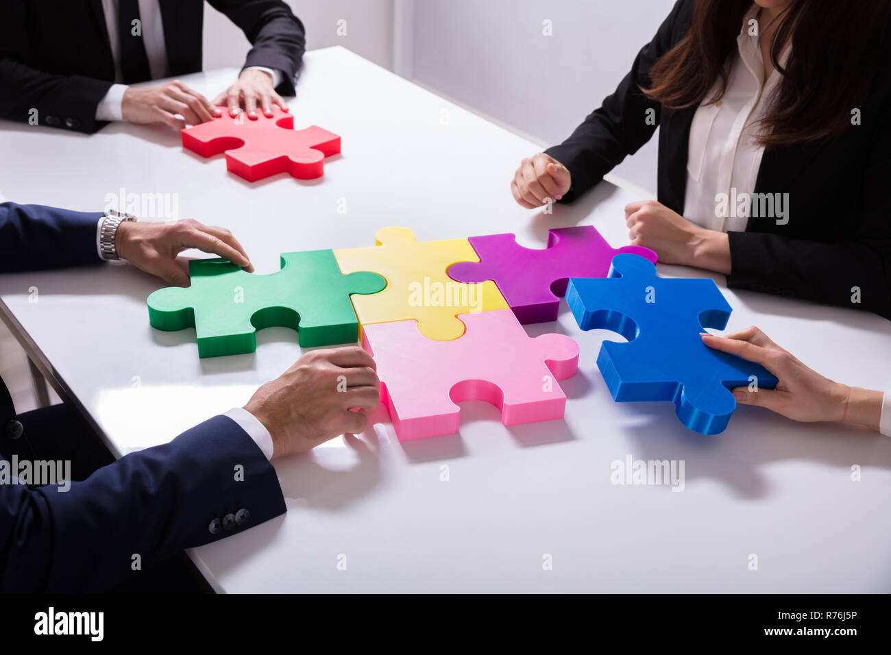 Businessmen with puzzle pieces table hi-res stock photography and ...