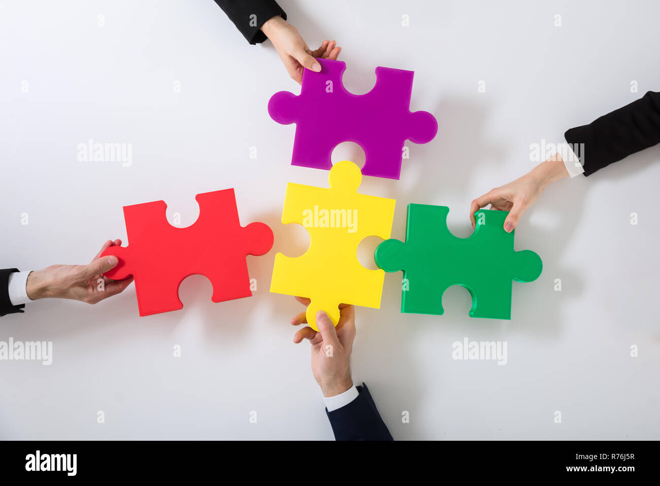 Businessmen with puzzle pieces table hi-res stock photography and ...