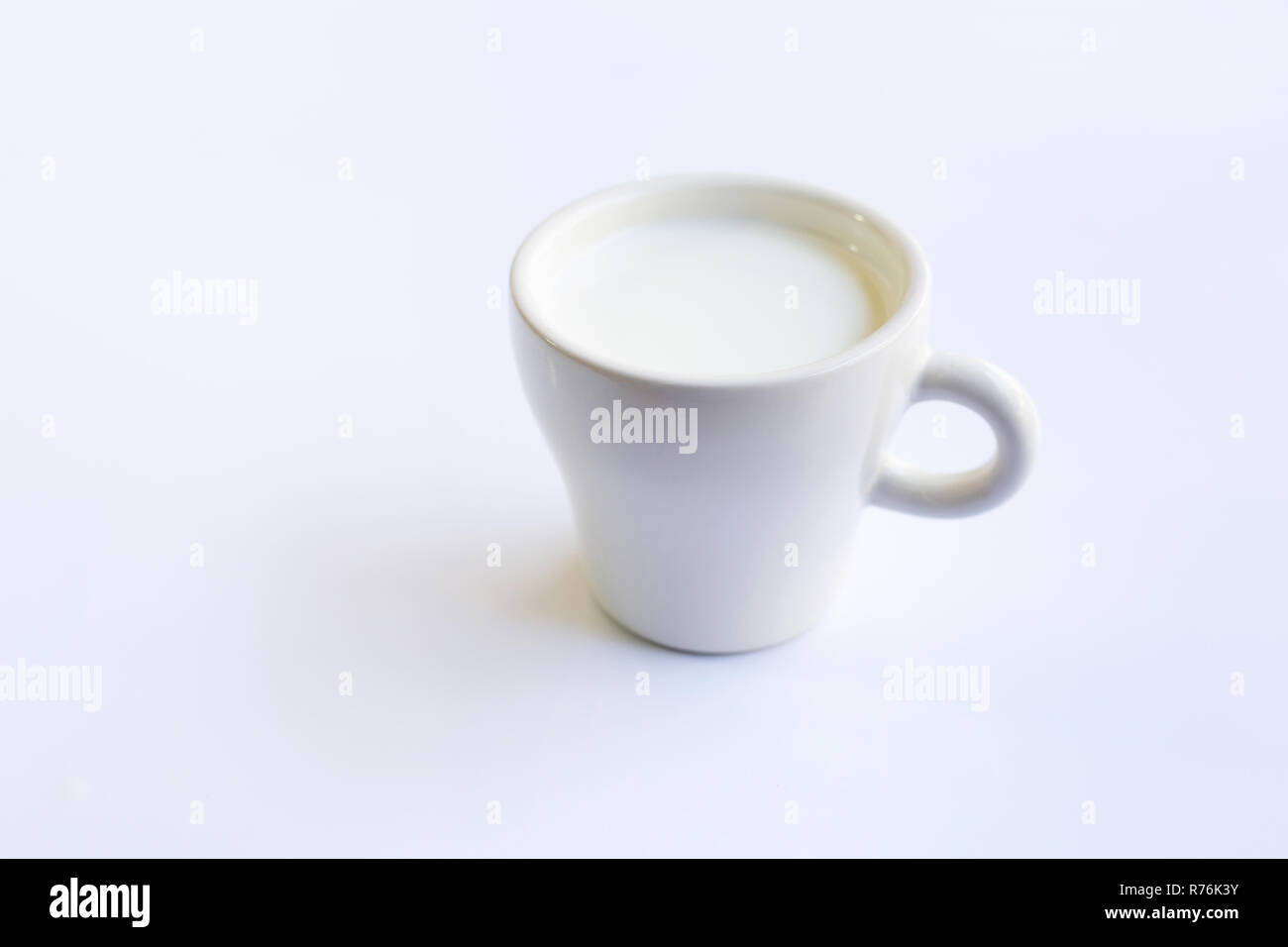 Cup of milk on white background Stock Photo - Alamy