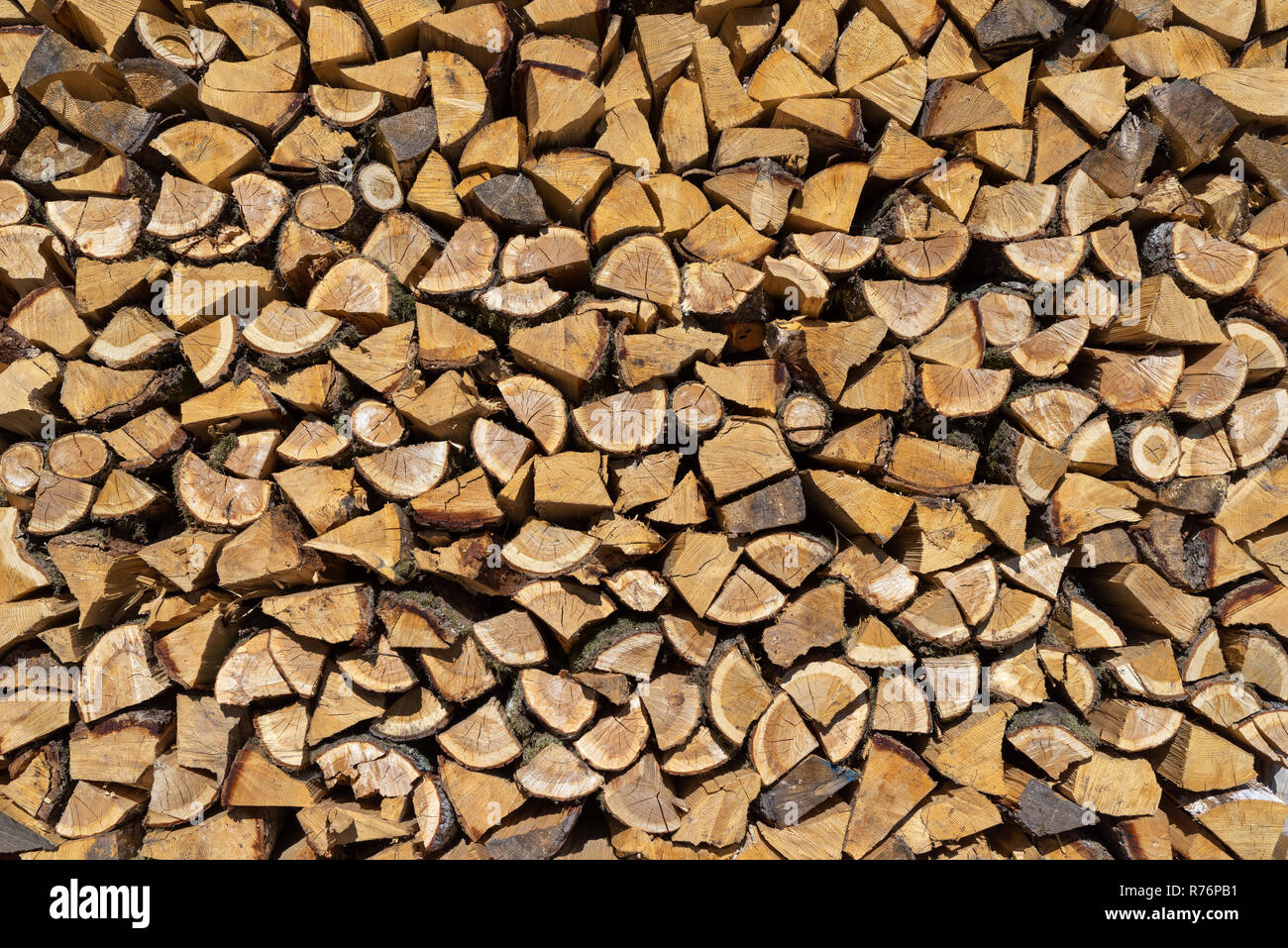 detail of a woodpile with many small logs in the sunshine Stock Photo ...