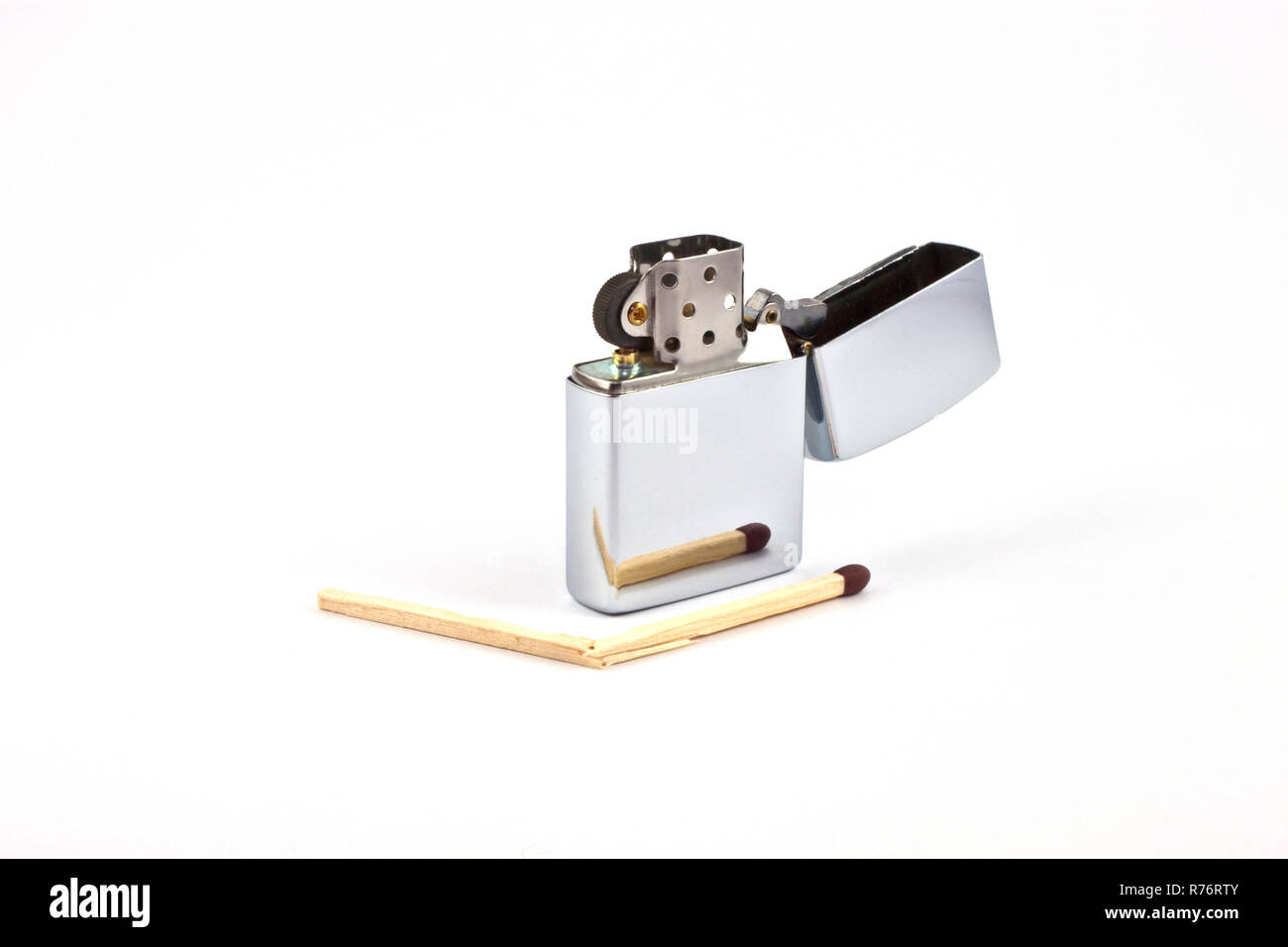 Broken match lyingin front of a shiny lighter Stock Photo - Alamy