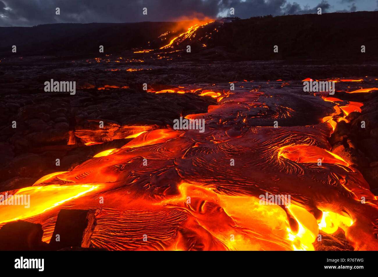 Pouring lava on the slope of the volcano. Volcanic eruption and magma ...