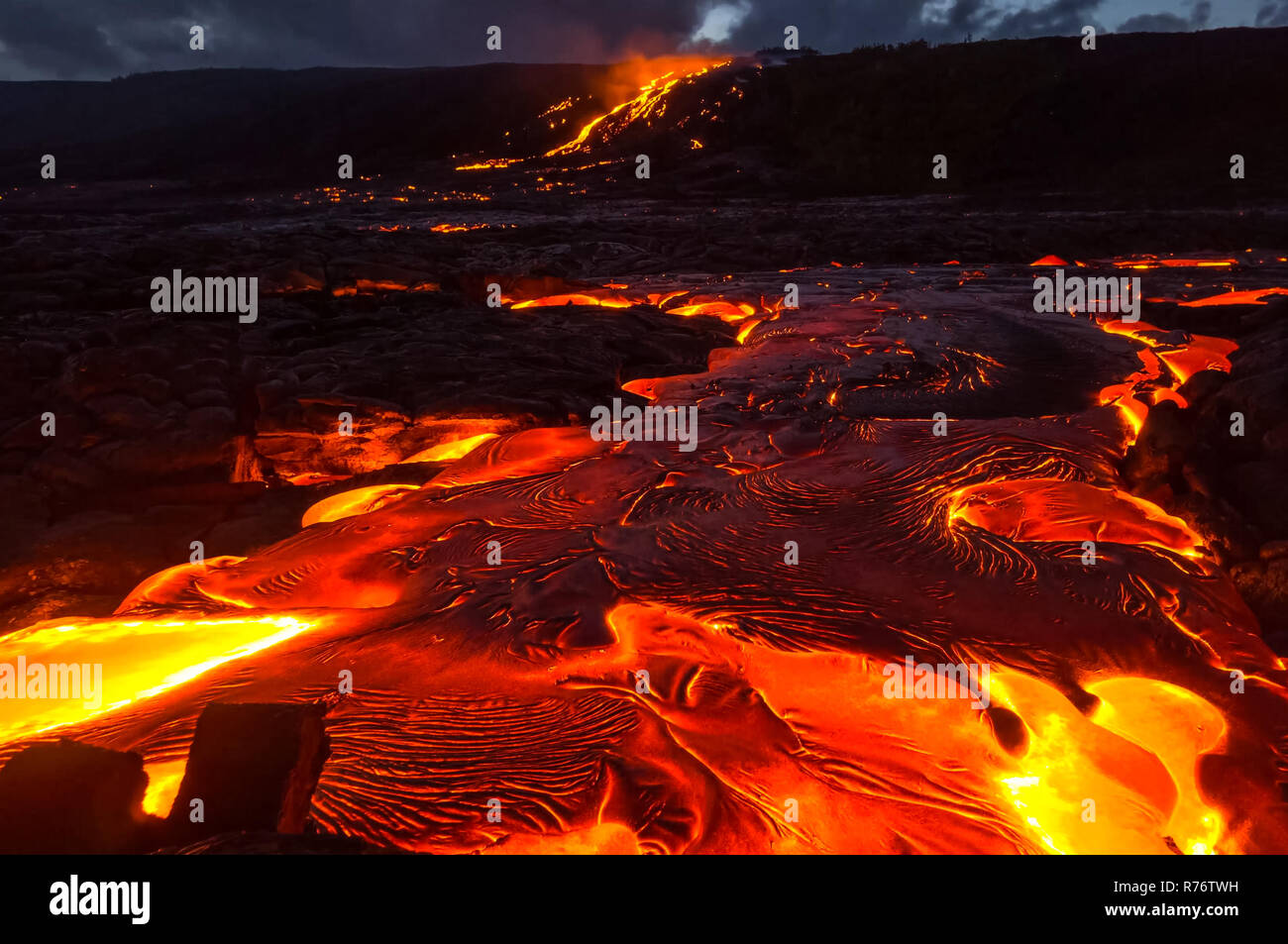 Pouring lava on the slope of the volcano. Volcanic eruption and magma ...