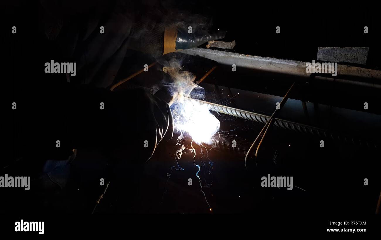 Welding of steel reinforcement. Sparks and light from welding. Electric ...