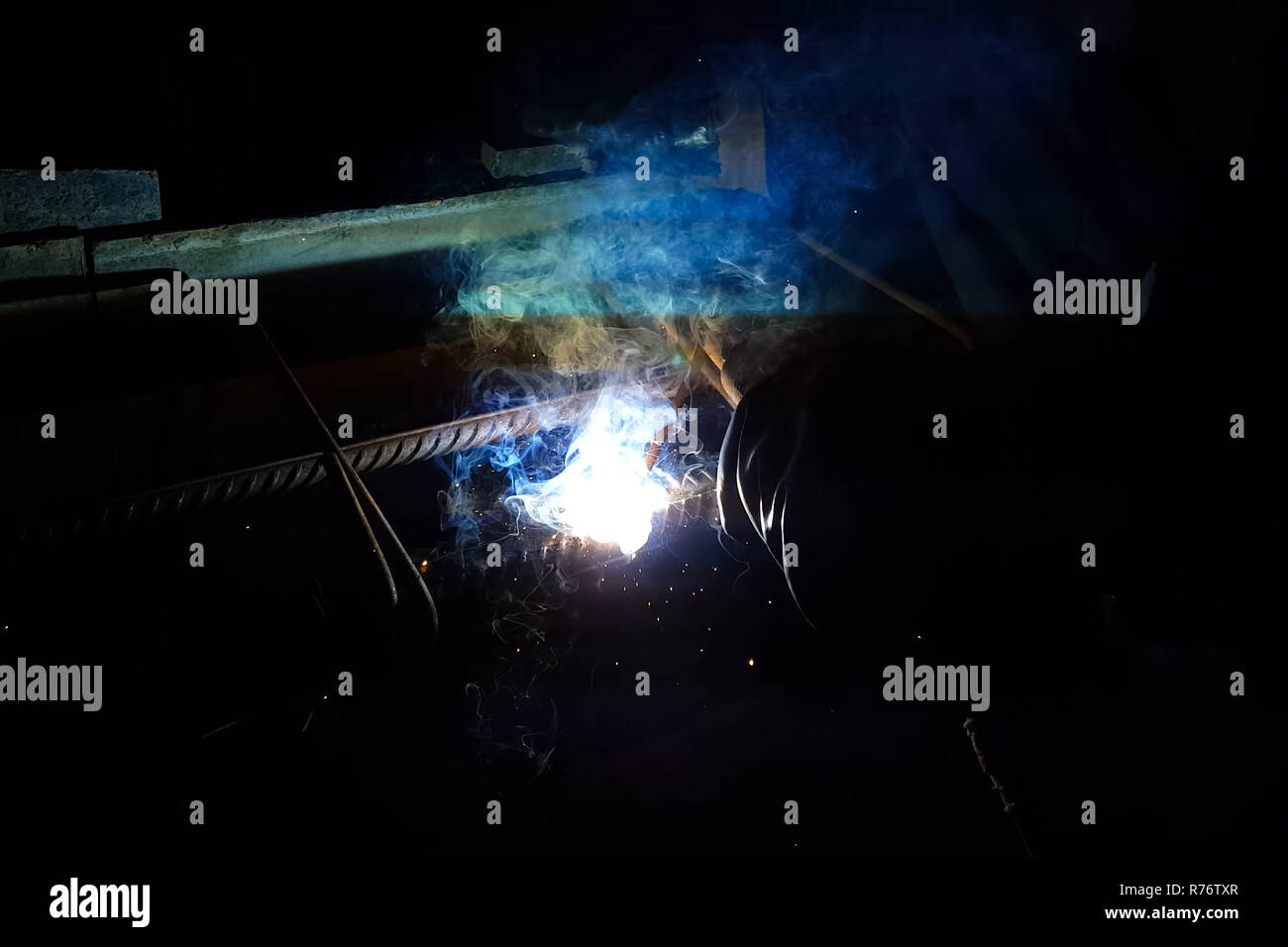 Welding of steel reinforcement. Sparks and light from welding. Electric ...