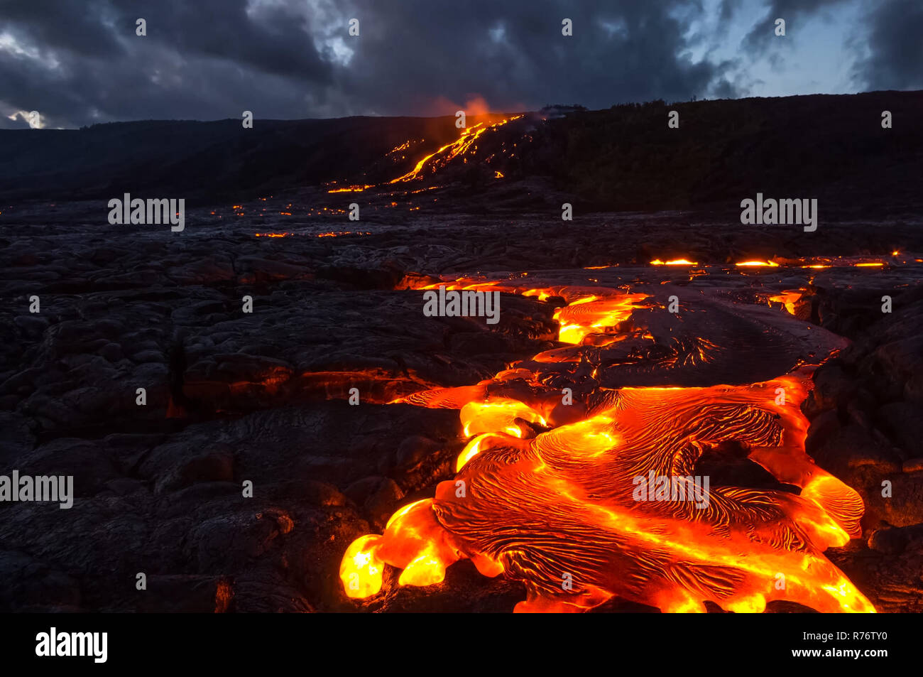 Pouring lava on the slope of the volcano. Volcanic eruption and magma ...