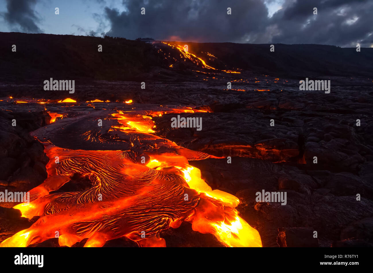 Pouring lava on the slope of the volcano. Volcanic eruption and magma ...
