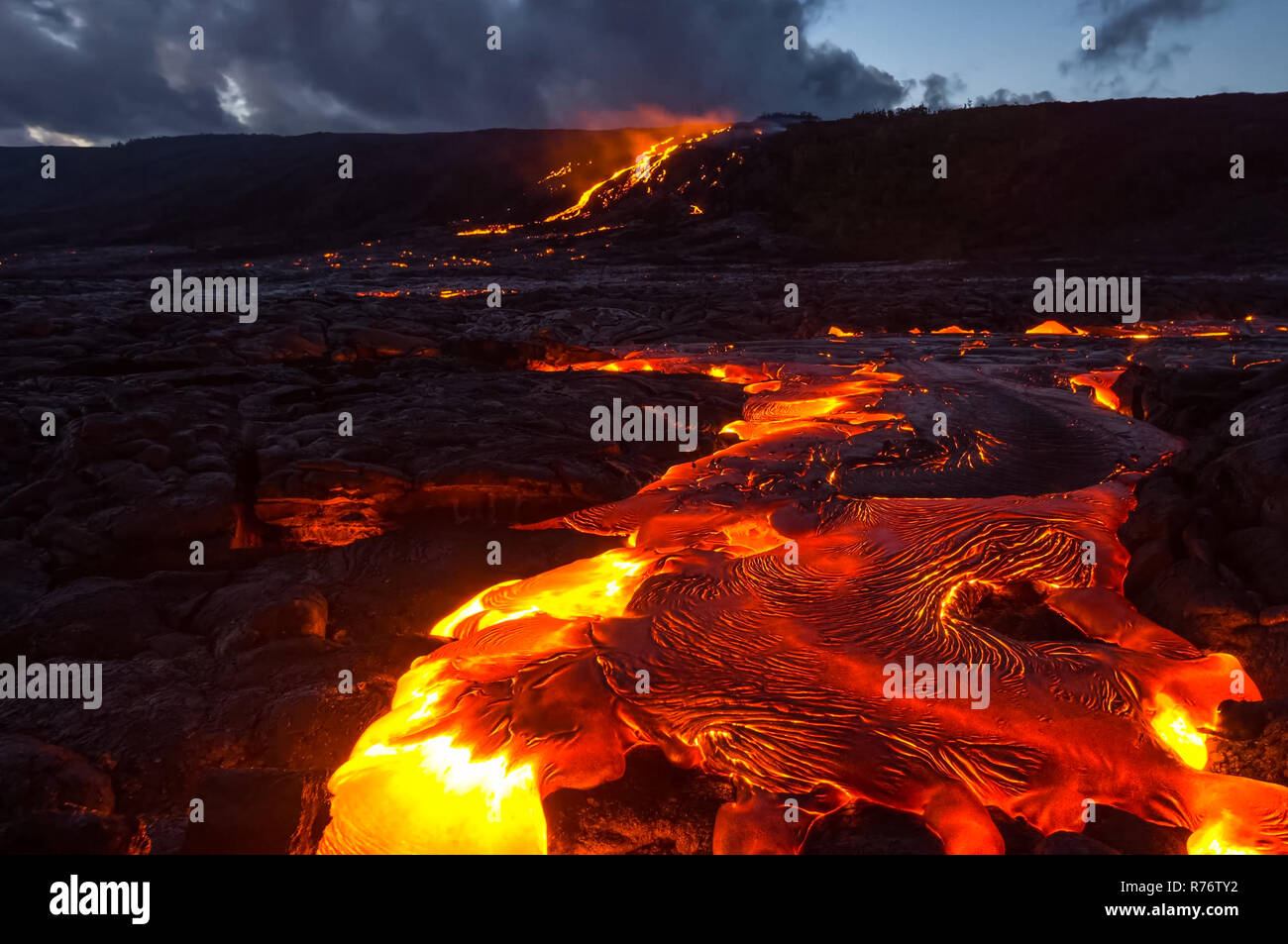Pouring lava on the slope of the volcano. Volcanic eruption and magma ...