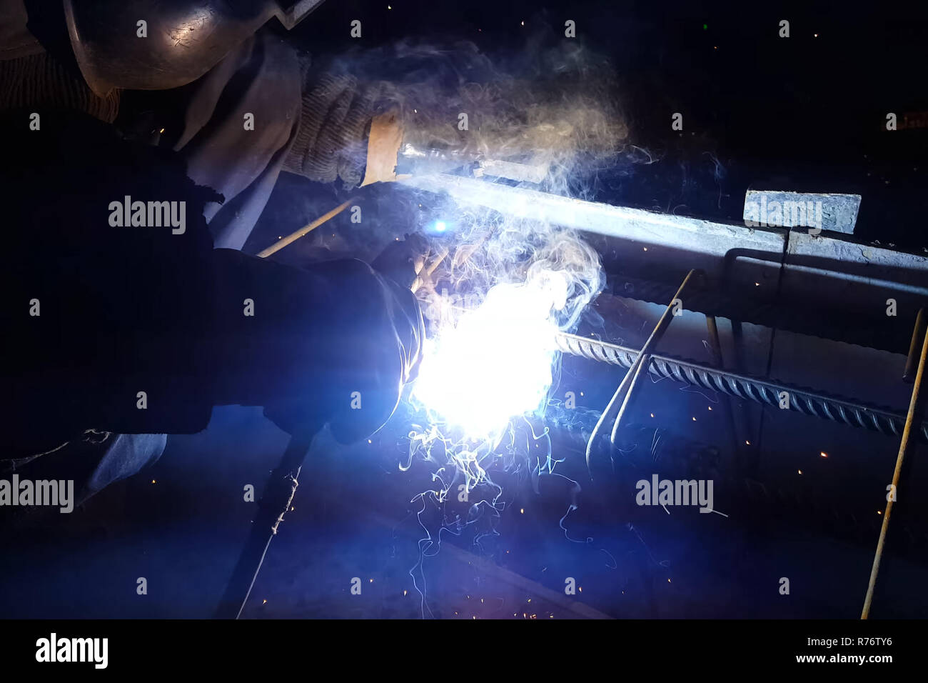 Welding of steel reinforcement. Sparks and light from welding. Electric ...