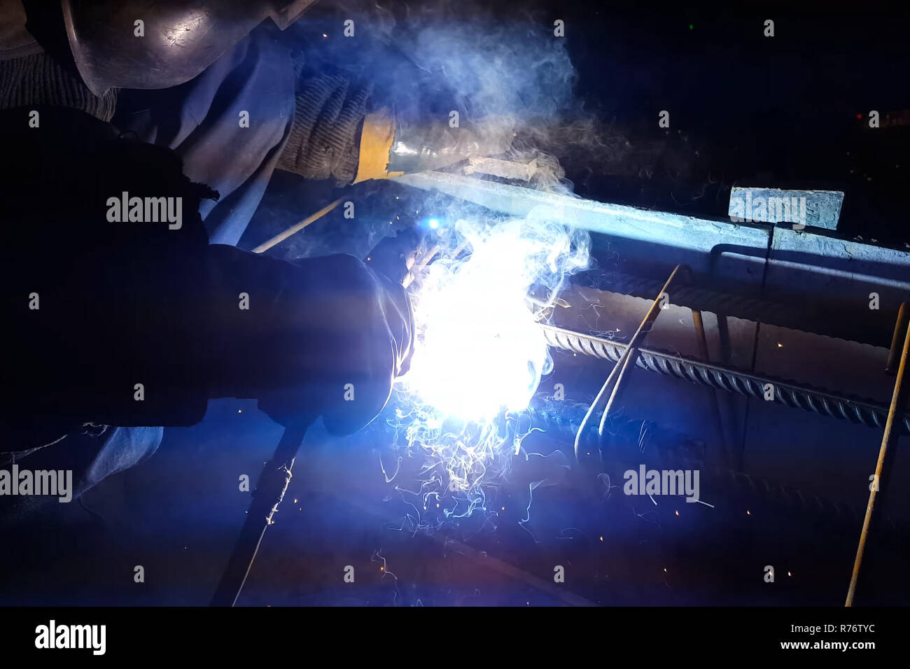 Welding of steel reinforcement. Sparks and light from welding. Electric ...
