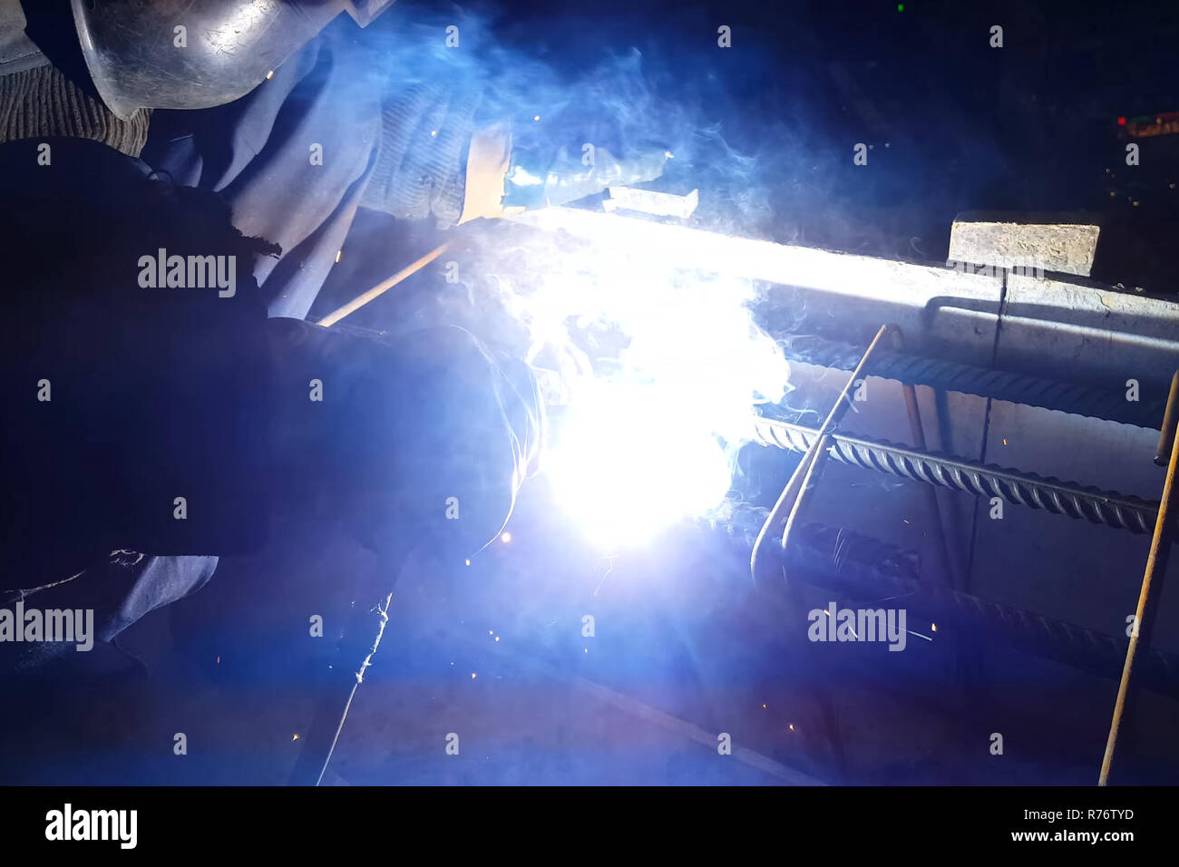 Welding of steel reinforcement. Sparks and light from welding. Electric ...