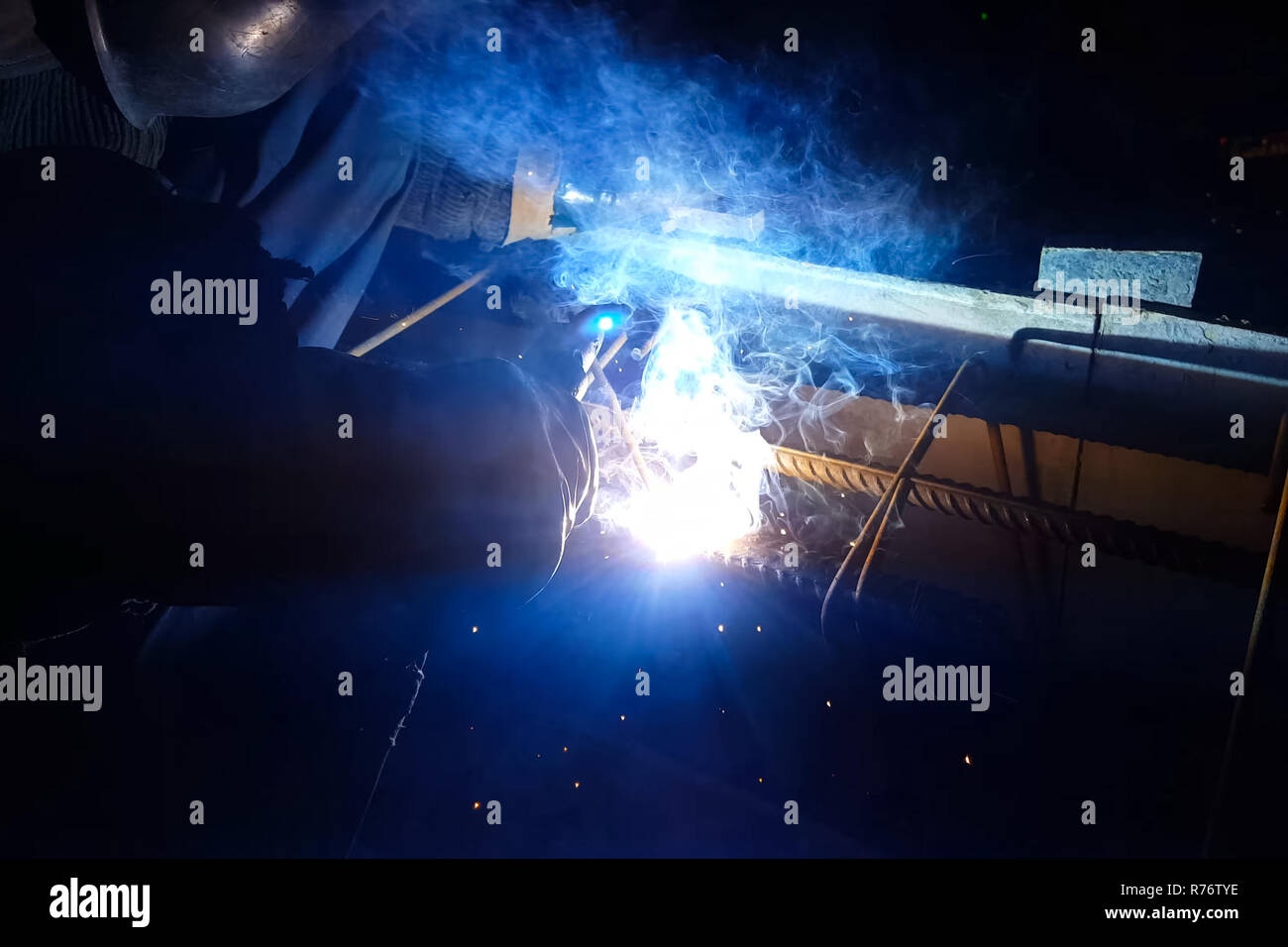 Welding of steel reinforcement. Sparks and light from welding. Electric ...