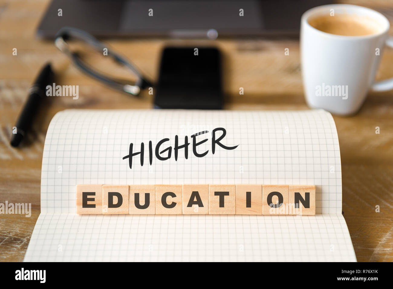 Closeup on notebook over vintage desk background, front focus on wooden ...