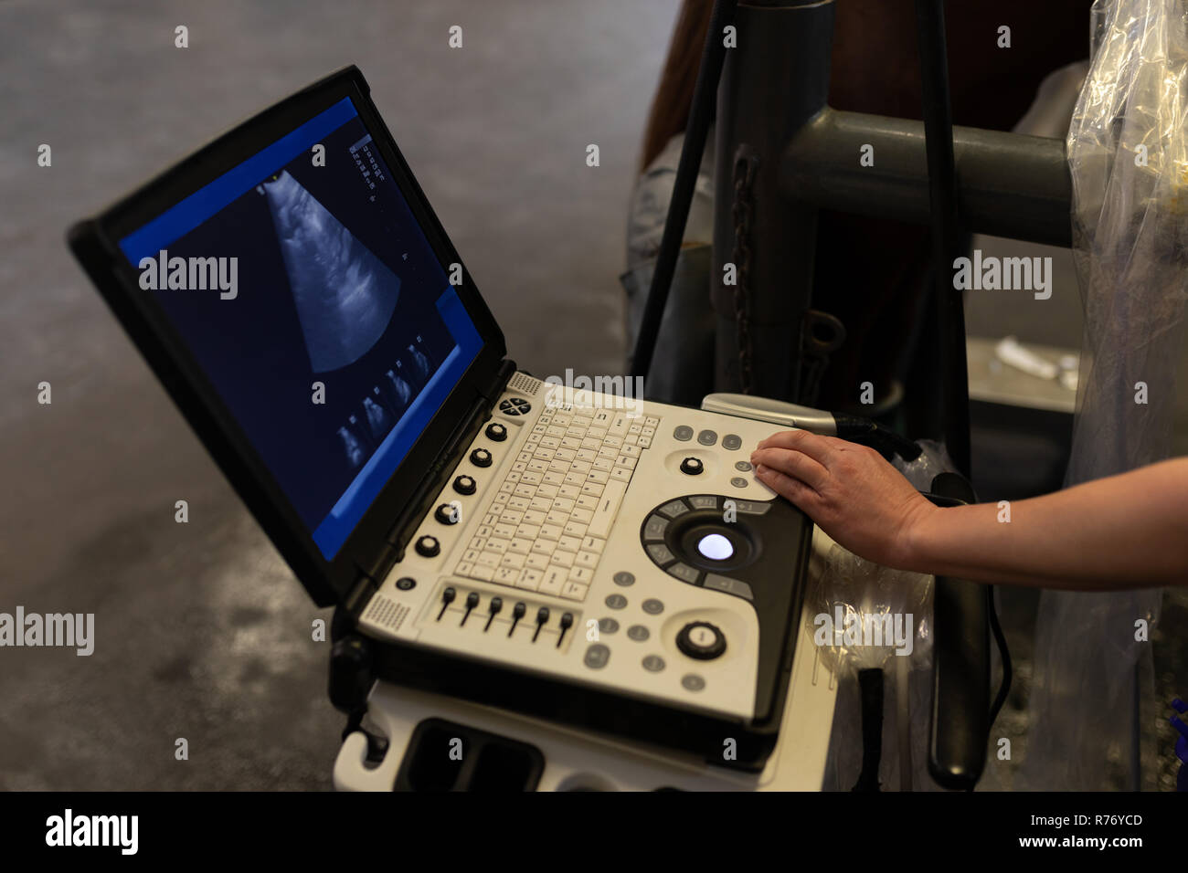 Surgeon using electronic device in hospital Stock Photo - Alamy