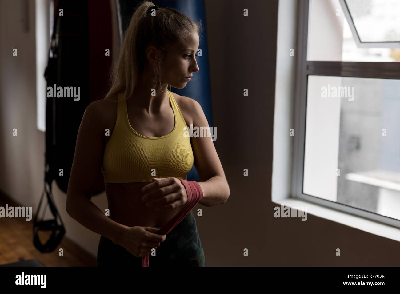 Female boxer wearing hand wrap in fitness studio Stock Photo - Alamy