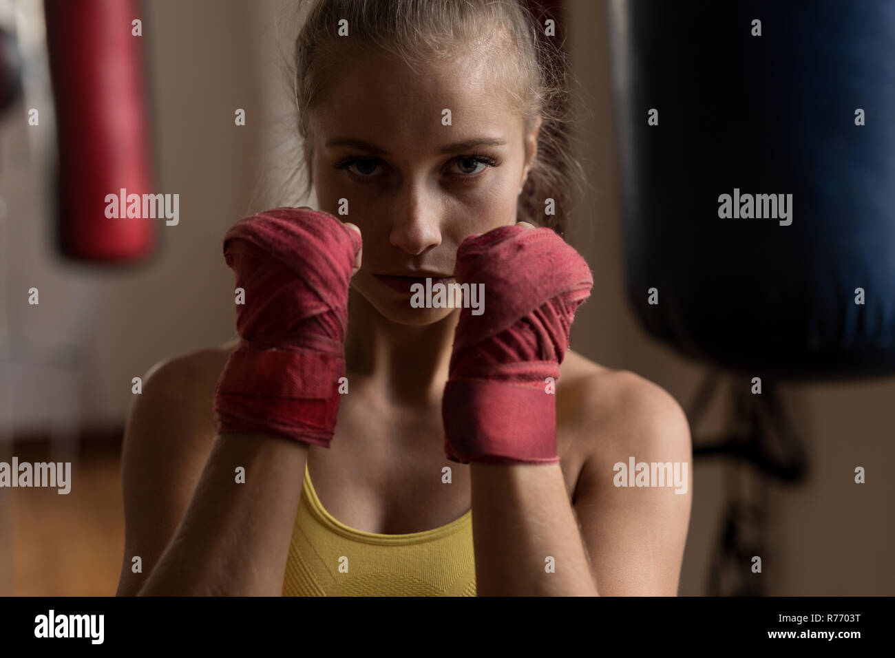 Female boxer forming hand fist in fitness studio Stock Photo - Alamy