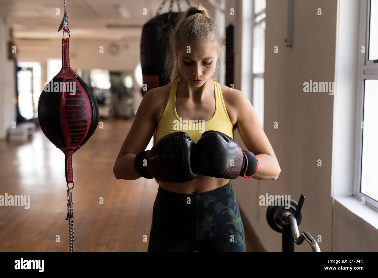 Female boxer forming hand fist in fitness studio Stock Photo - Alamy