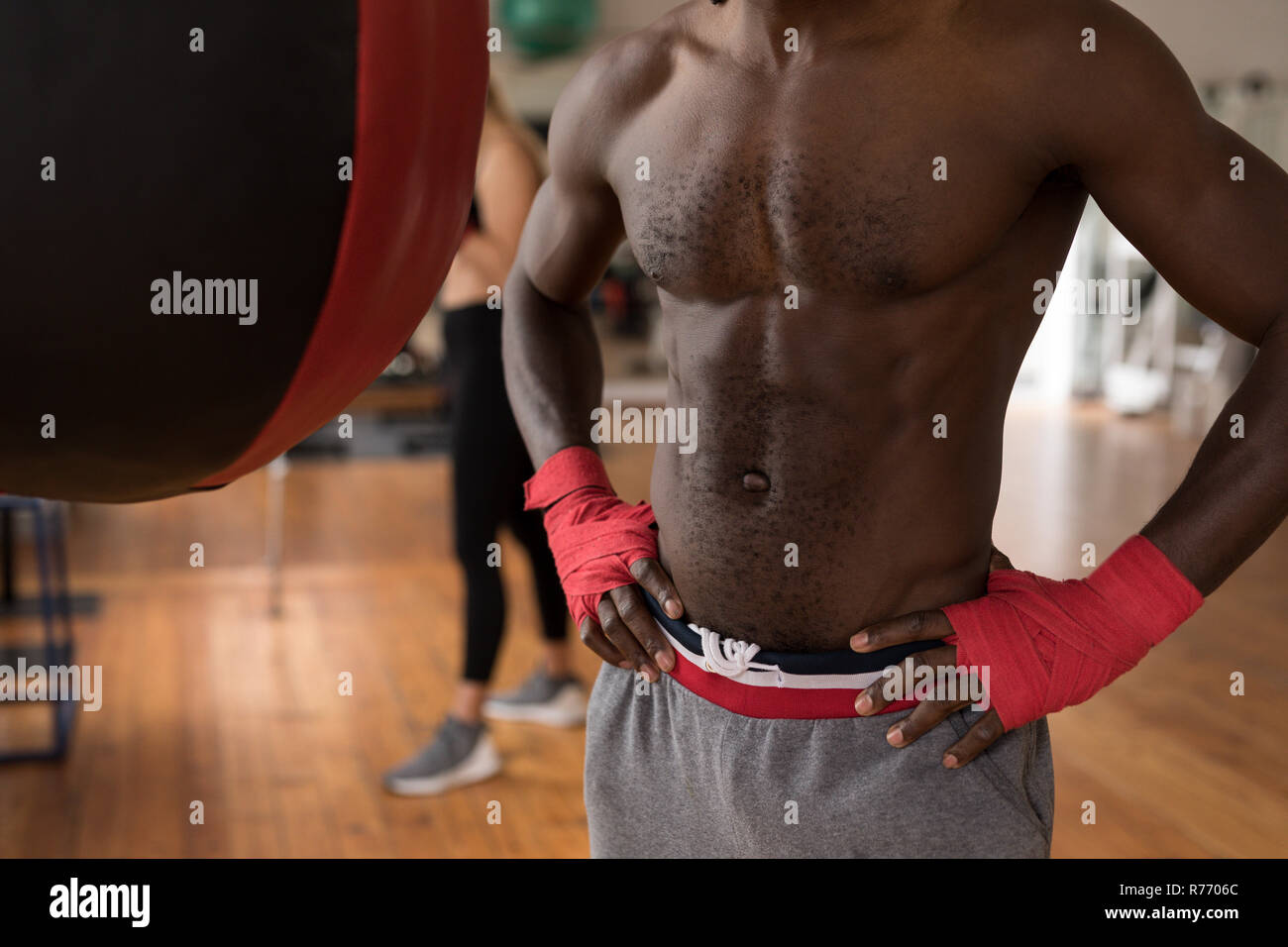 Male boxer standing with hands on hips in fitness studio Stock Photo ...