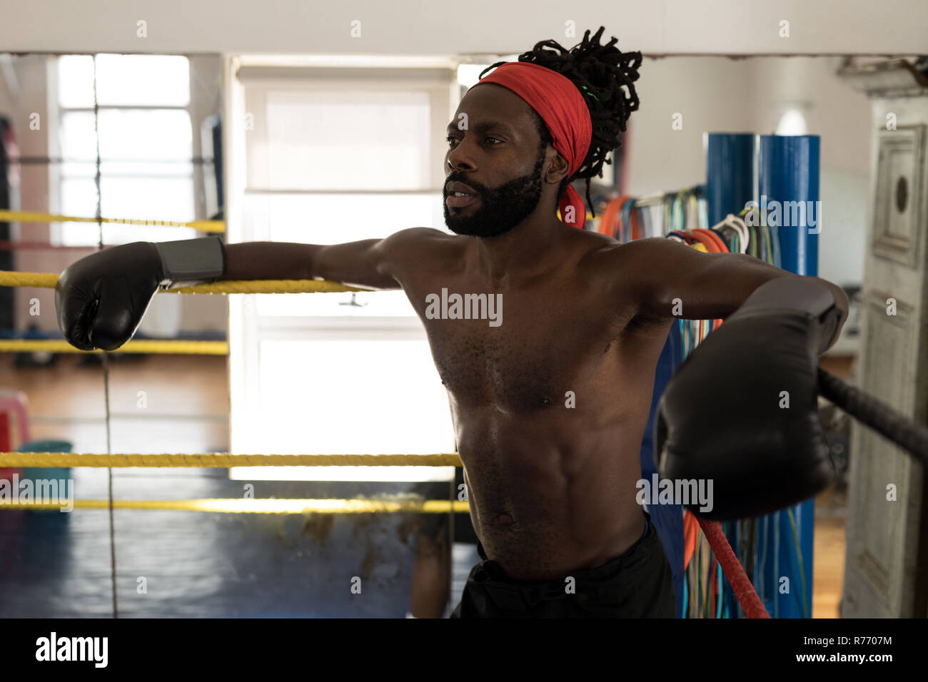 Male boxer relaxing in boxing ring at fitness studio Stock Photo - Alamy