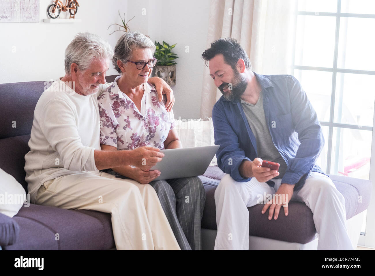 Aged family scene at home with mother father adult mature senior and ...