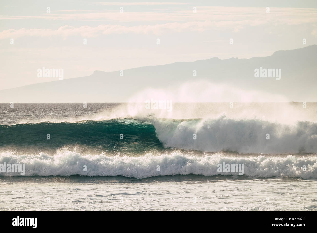 Big wave rolling it and crush at the beach with another tropical island ...
