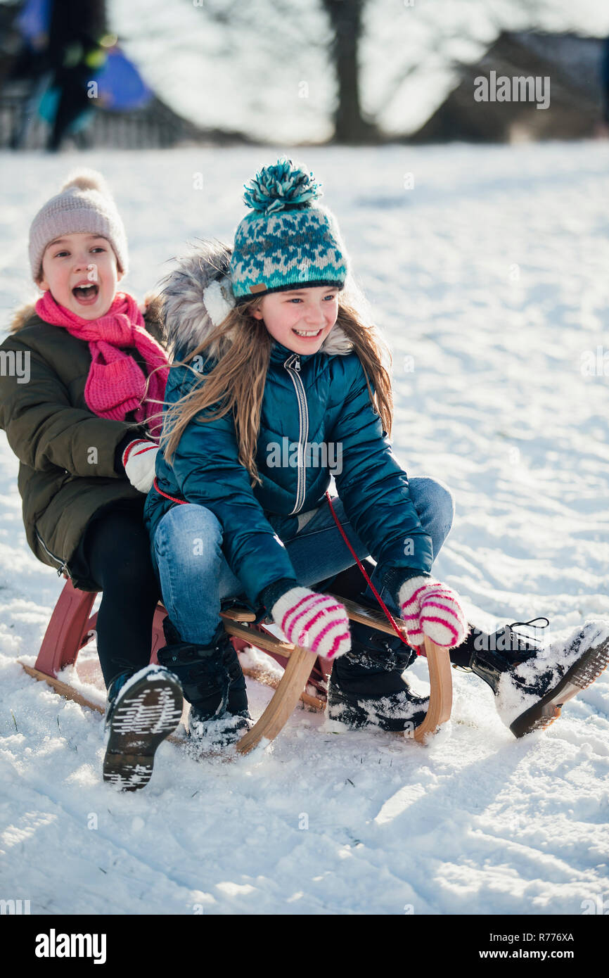 Girls Sledding Down a Hill Stock Photo - Alamy