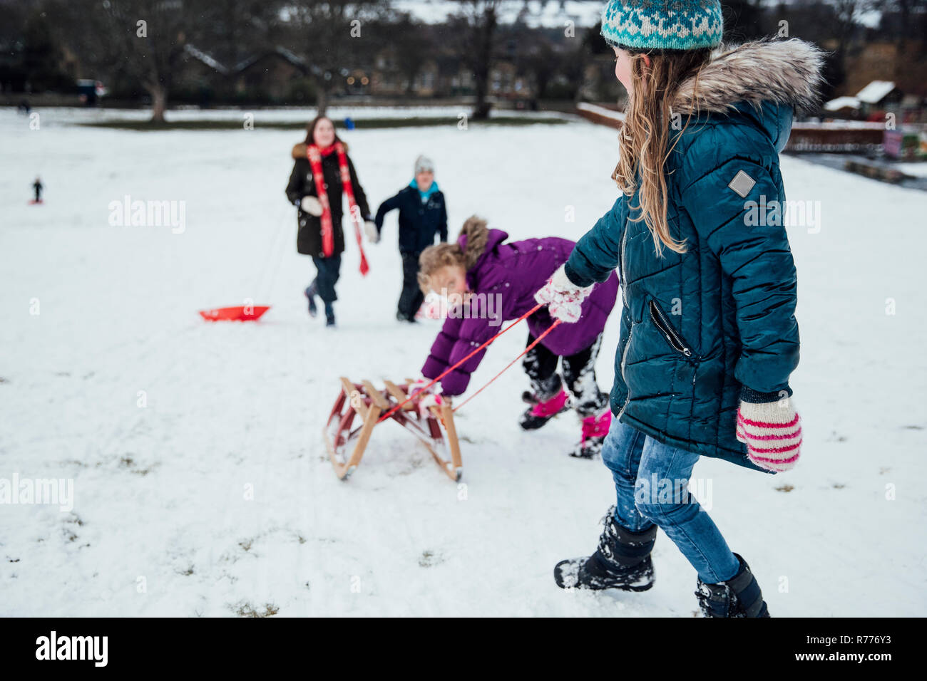 Kids pulling and pushing sled hi-res stock photography and images - Alamy