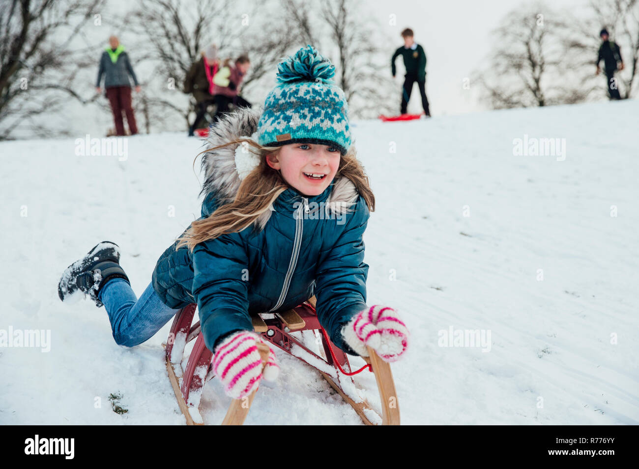 Little Girl on a Sled Stock Photo - Alamy