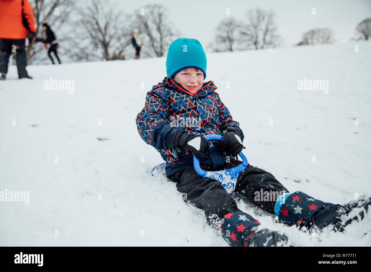 Little Boy on a Sled Stock Photo - Alamy