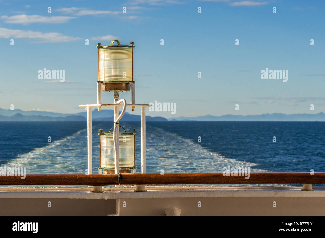 Glass and metal exterior sternlight of cruise ship, backlit by bright ...