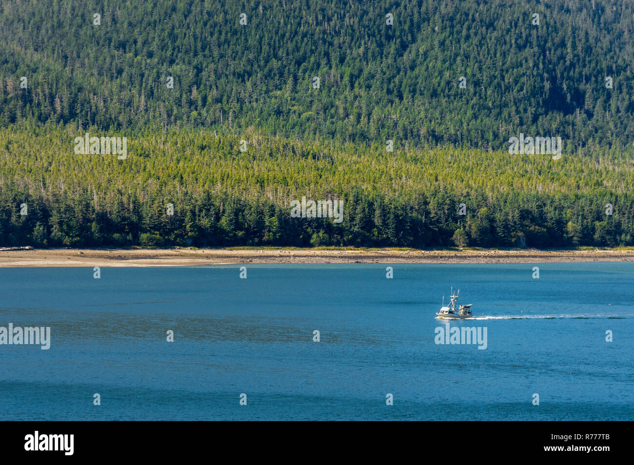 Southbound small white fishing boat on bright sunny blue sky day ...
