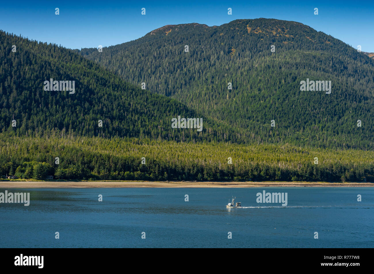 Southbound small white fishing boat on bright sunny blue sky day ...