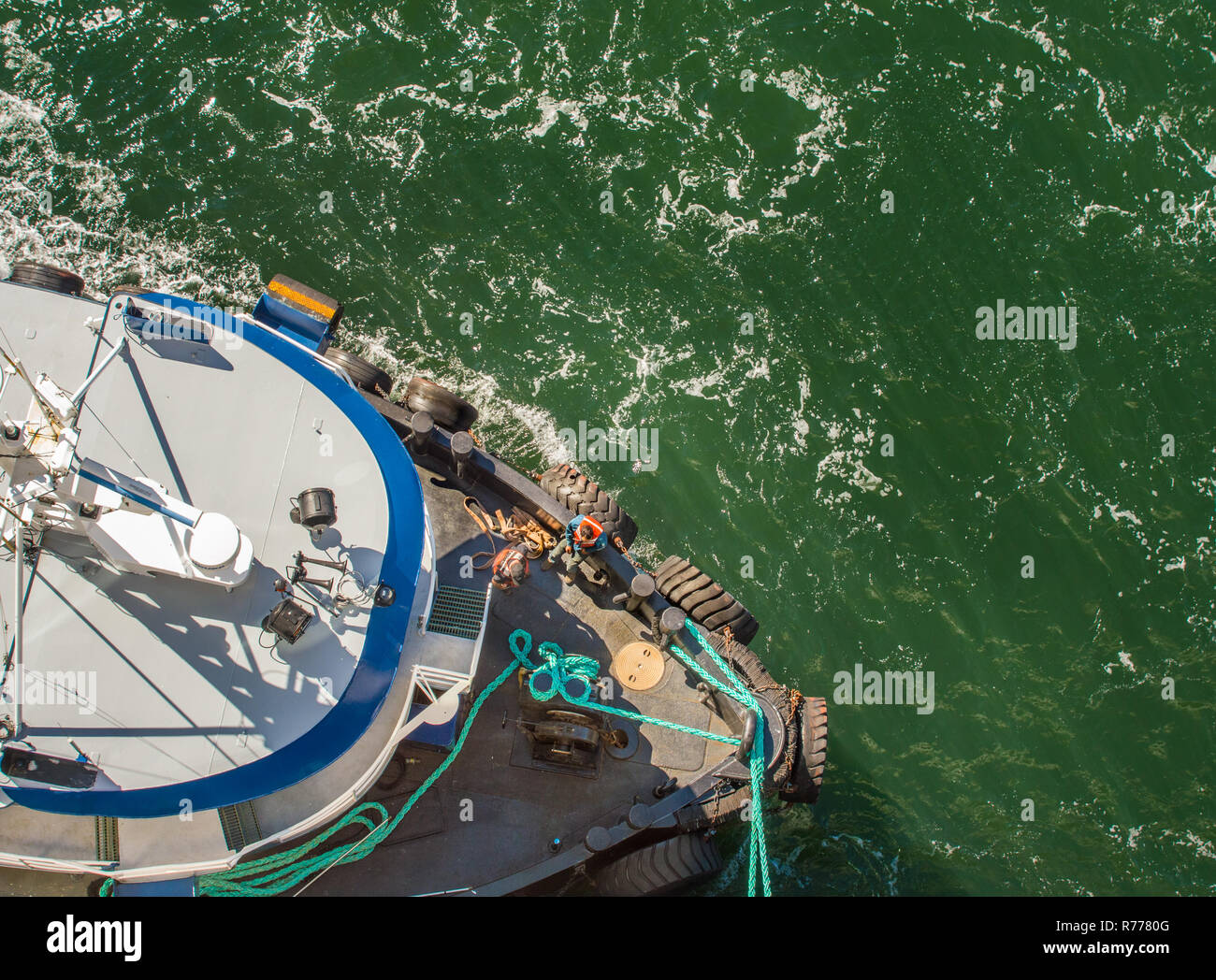 Tug boat guiding towing large ship hi-res stock photography and images ...