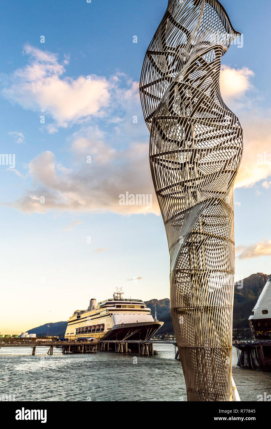 Metal abstract sculptures along dock of cruise ship port, with ships ...