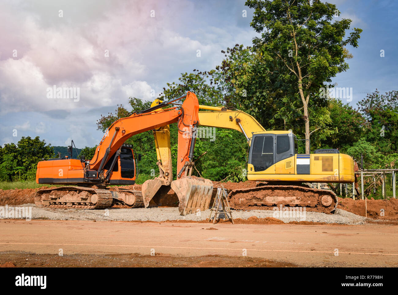 road construction with backhoe loader / yellow and orange modern ...