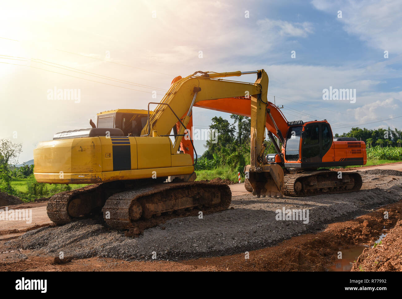road construction with backhoe loader / yellow and orange modern ...