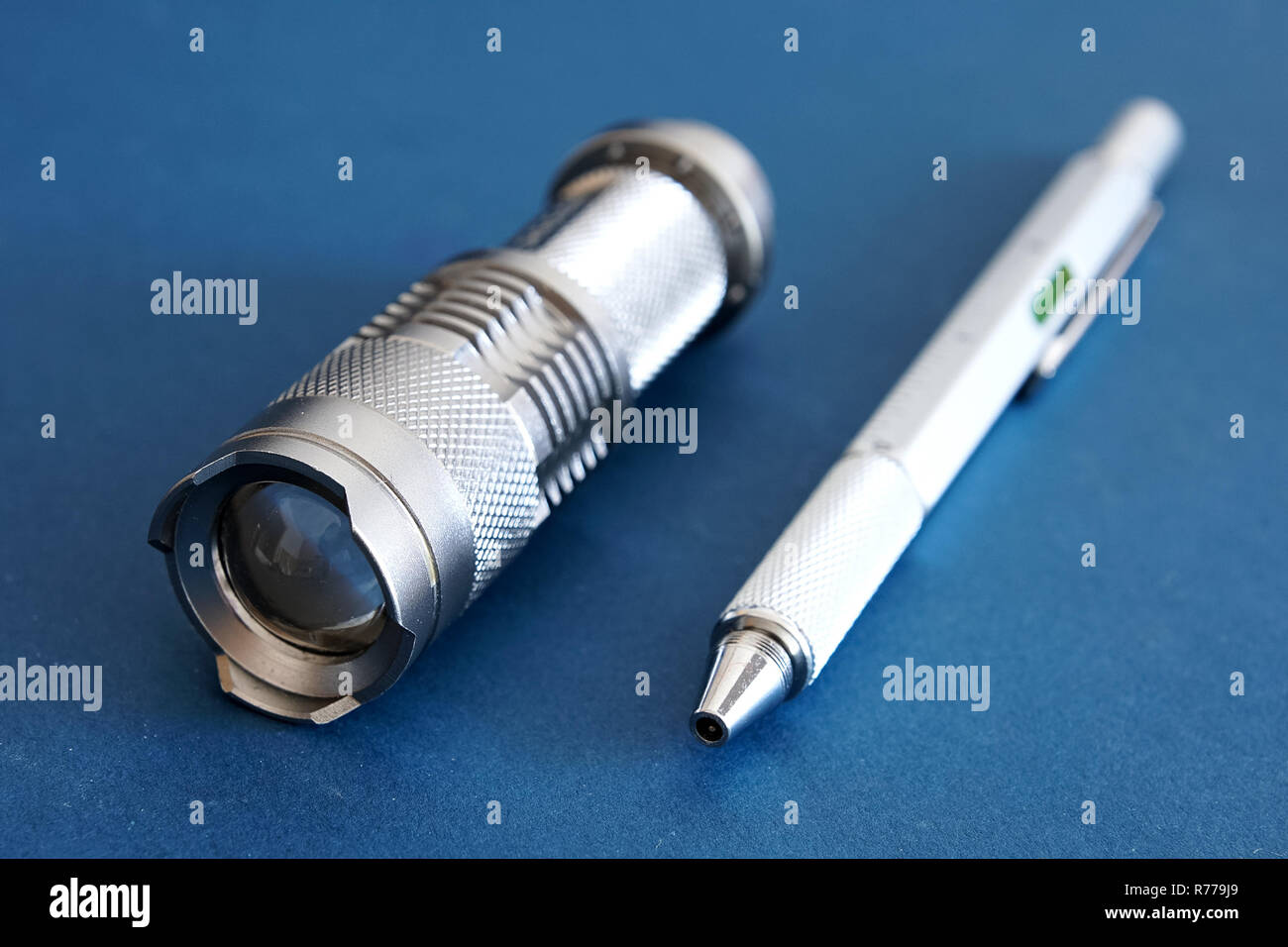 Products from aluminum, a flashlight and a writing pen Stock Photo - Alamy