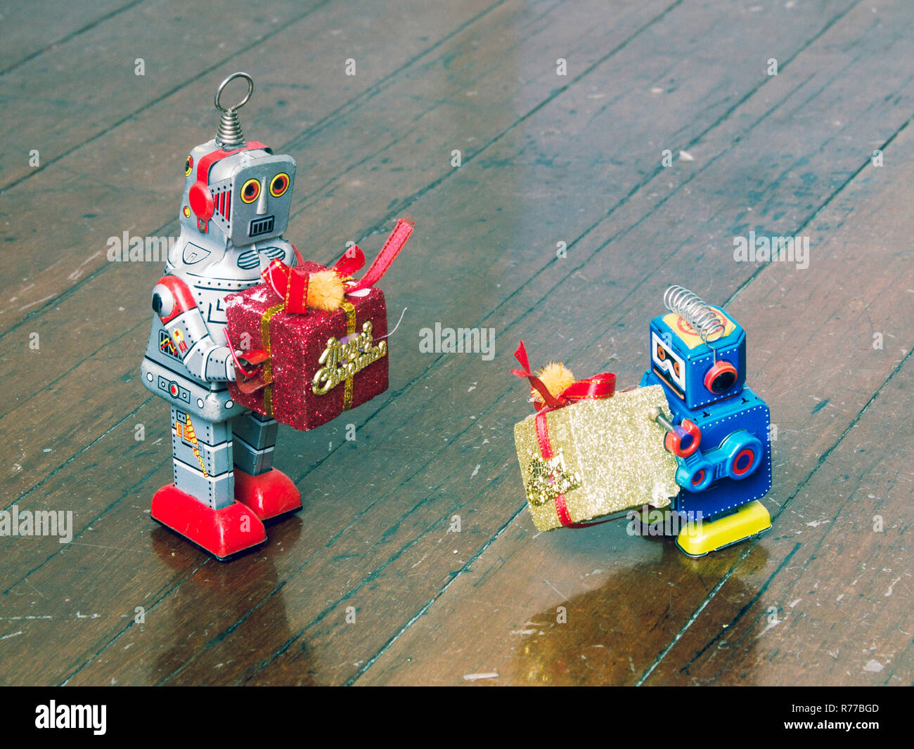 retro robots with gifts on a old wooden floor with reflection Stock ...