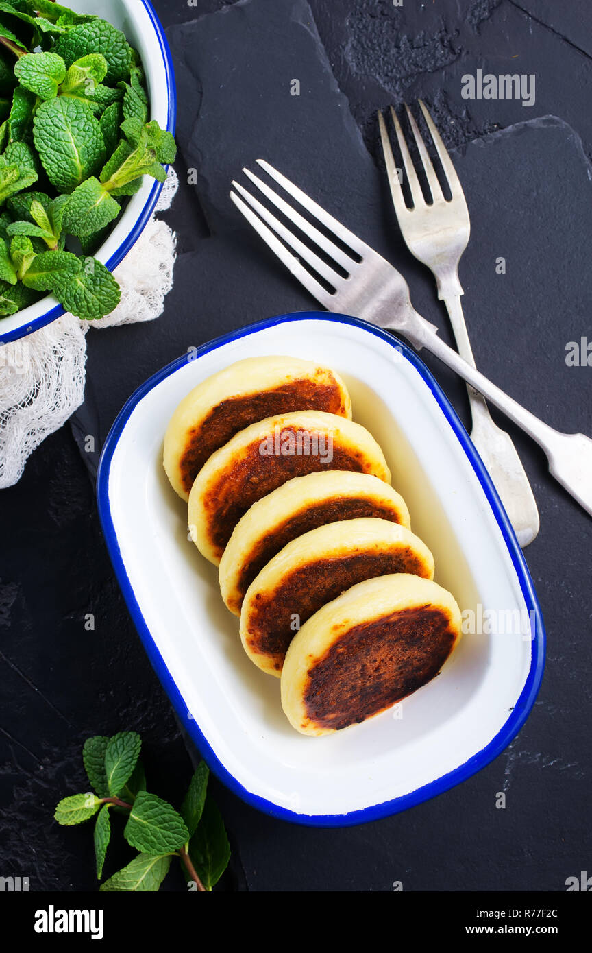 cottage cheese pancakes syrniki on plate, cheese pancakes and mint ...