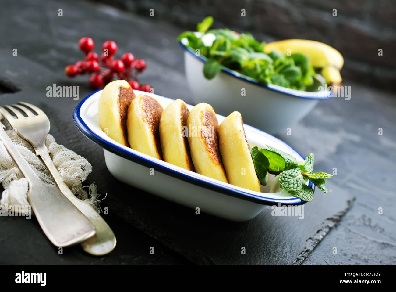 cottage cheese pancakes syrniki on plate, cheese pancakes and mint ...