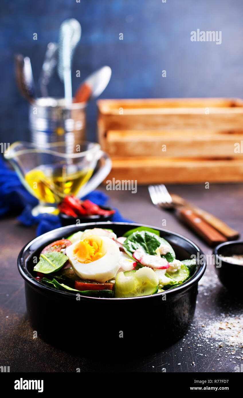 boiled eggs with vegetables in black bowl Stock Photo - Alamy