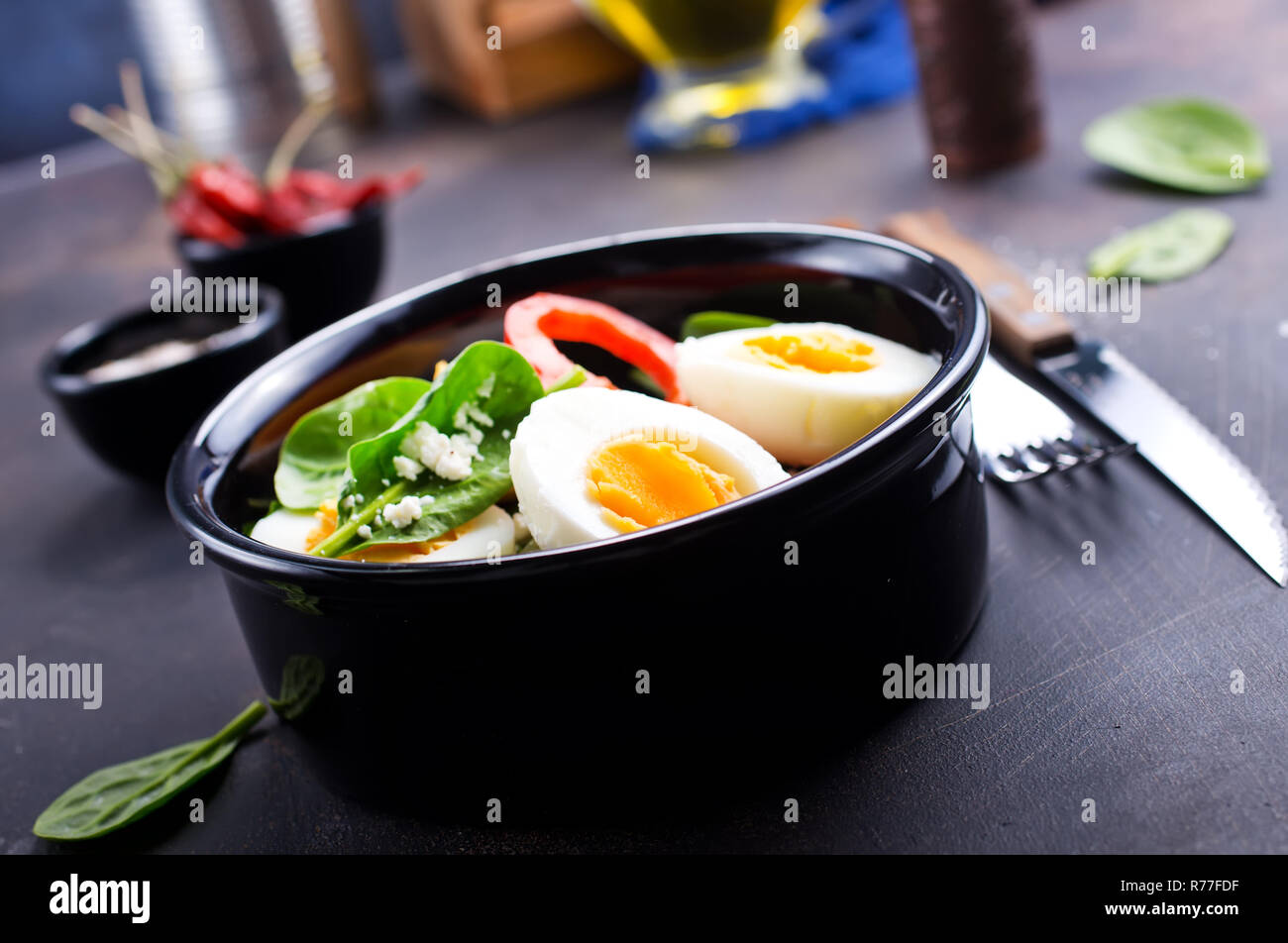 boiled eggs with vegetables in black bowl Stock Photo - Alamy