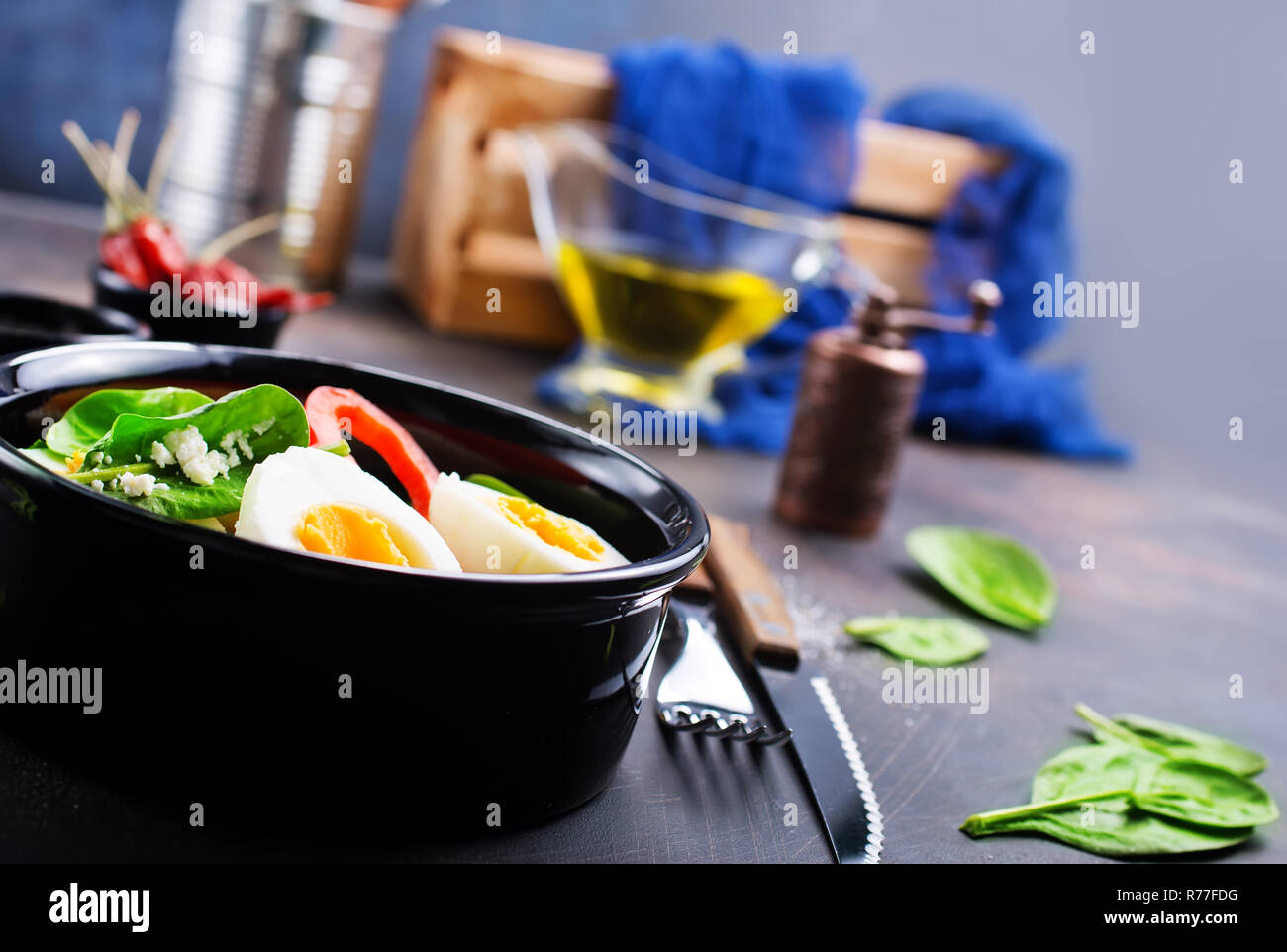 boiled eggs with vegetables in black bowl Stock Photo - Alamy