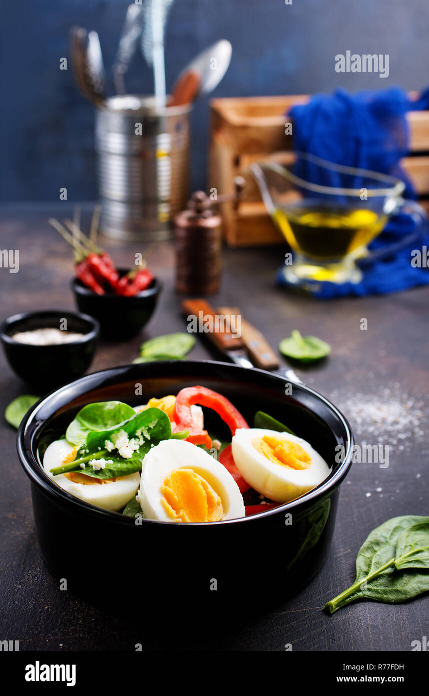boiled eggs with vegetables in black bowl Stock Photo - Alamy