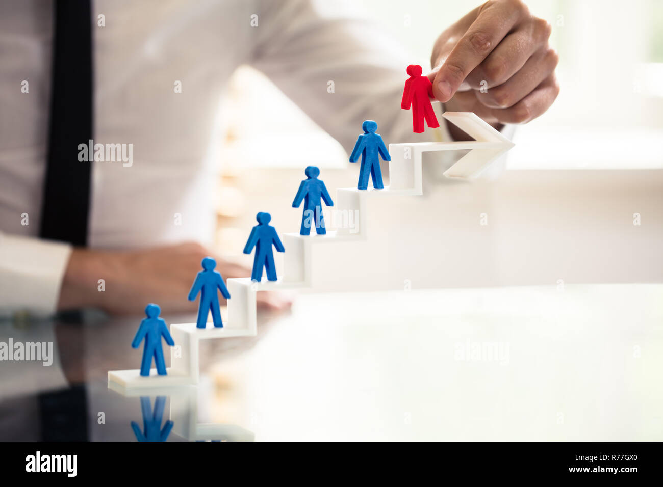 Businessperson Picking Red Human Figure Stock Photo - Alamy
