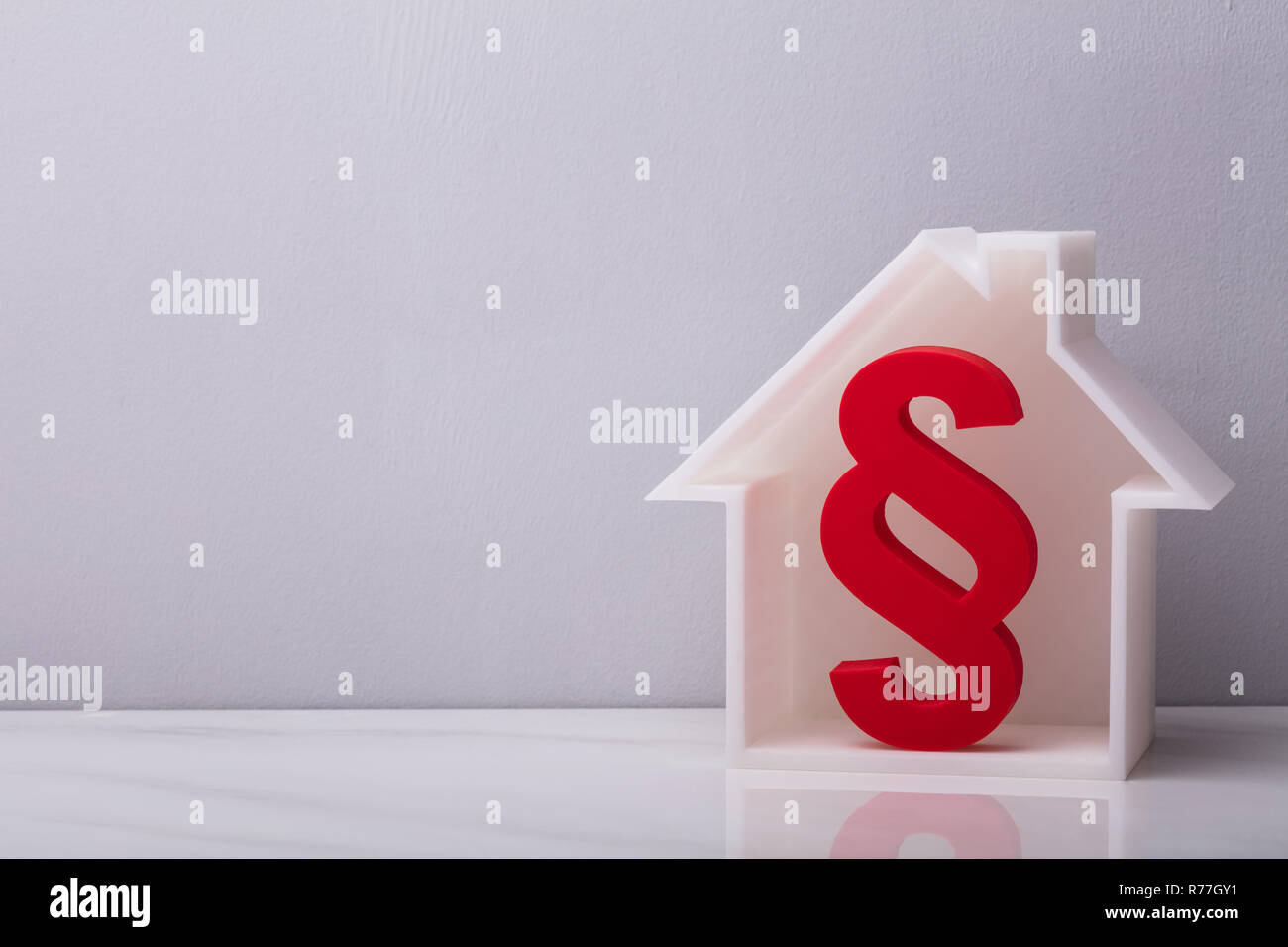 Close-up Of Red Paragraph Symbol Inside House Model Stock Photo - Alamy