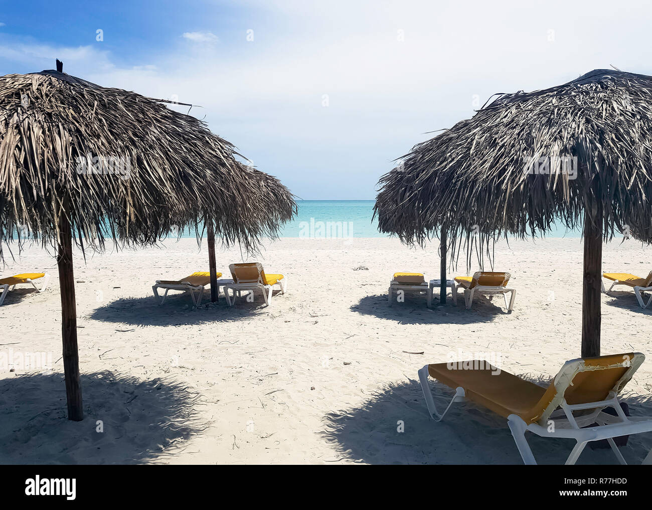 Cuban beach, umbrellas and sunbeds with Atlantic Ocean in background ...