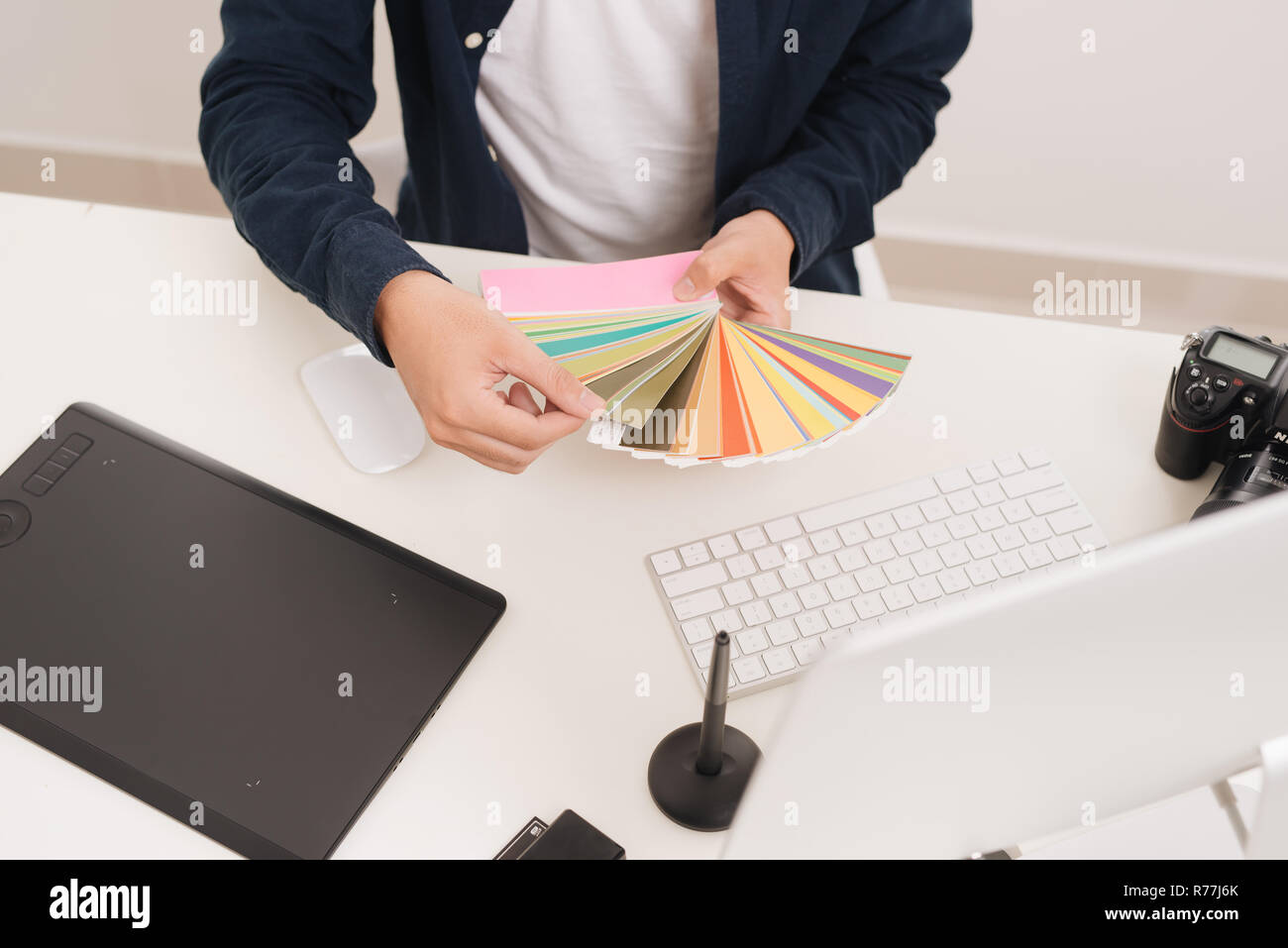 Photographer working at desk in modern office Stock Photo - Alamy