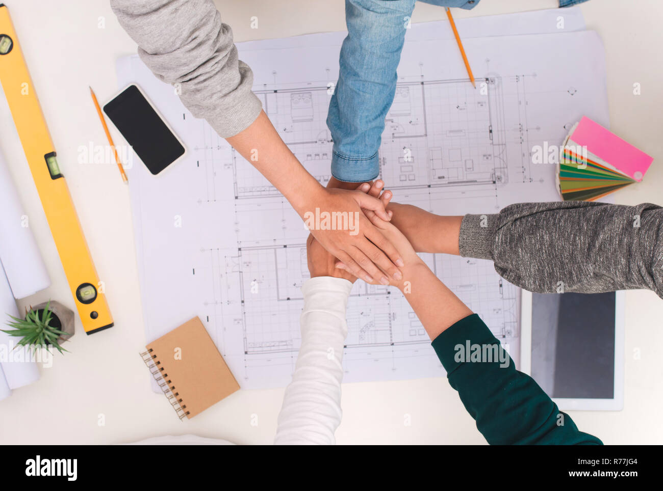 Group coworkers putting hands together hi-res stock photography and ...